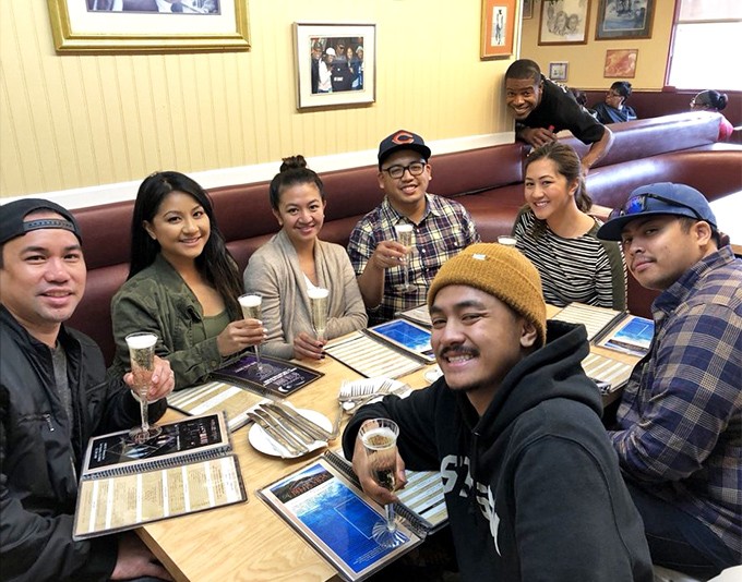 Good food brings good people together. These diners aren't just eating breakfast &ndash; they're creating memories that will outlast the meal itself.