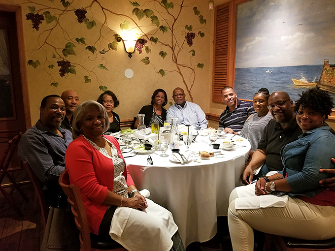 Great Italian food brings people together. This table isn't just sharing a meal—they're creating memories that will last longer than the leftovers.