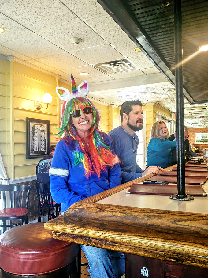 The rainbow unicorn headband says "party," but the coffee says "we need sustenance first."