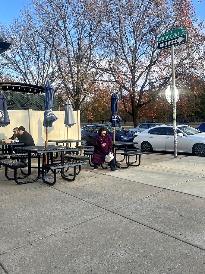 The Wendover Street sign watches over diners enjoying their spoils. Even in November, cheesesteak season is always in full swing.