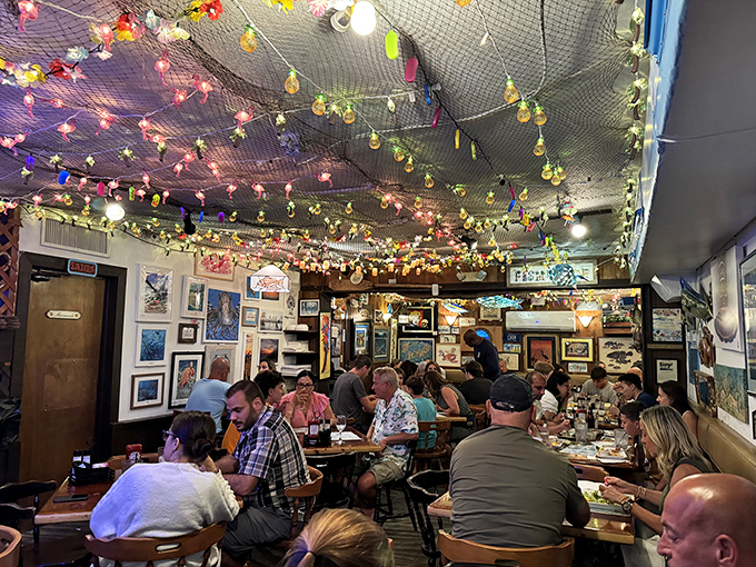 A packed house of happy diners under fishing nets and local art. The universal language of "mmm" needs no translation.