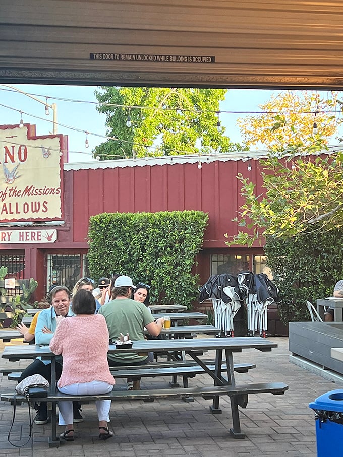 Communal tables encourage strangers to become friends, united by the universal language of exceptional barbecue in this charming patio setting.