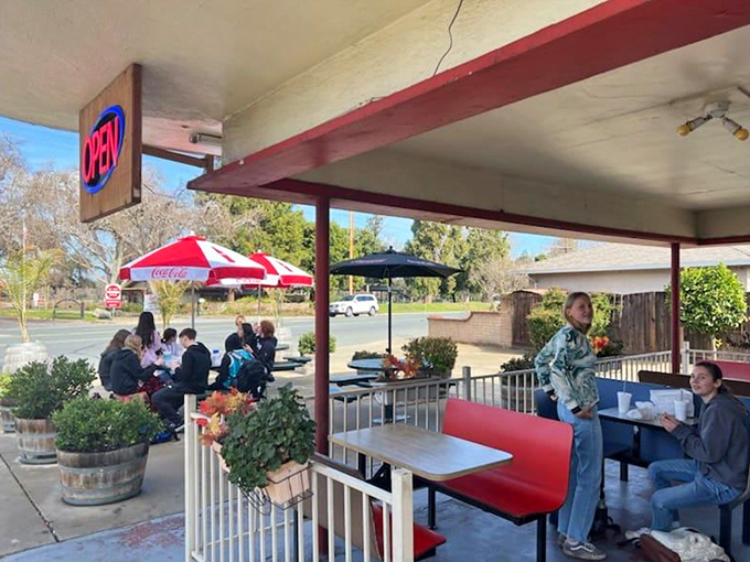 Where locals gather to share stories, sunshine, and seriously good food under the protective gaze of Coca-Cola umbrellas.