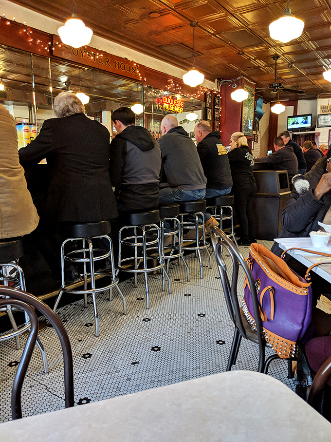 The bar fills with regulars who've been claiming these same stools since before cell phones, sharing stories over seafood and cold drinks.