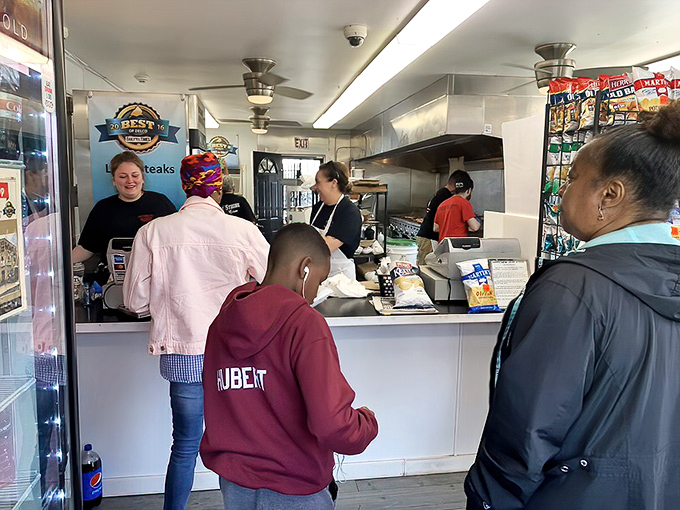 The anticipation is palpable. These customers know they're moments away from cheesesteak nirvana.