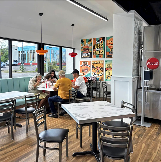 Fellow burger warriors in their natural habitat, united in the sacred struggle against gravity-defying sandwiches.