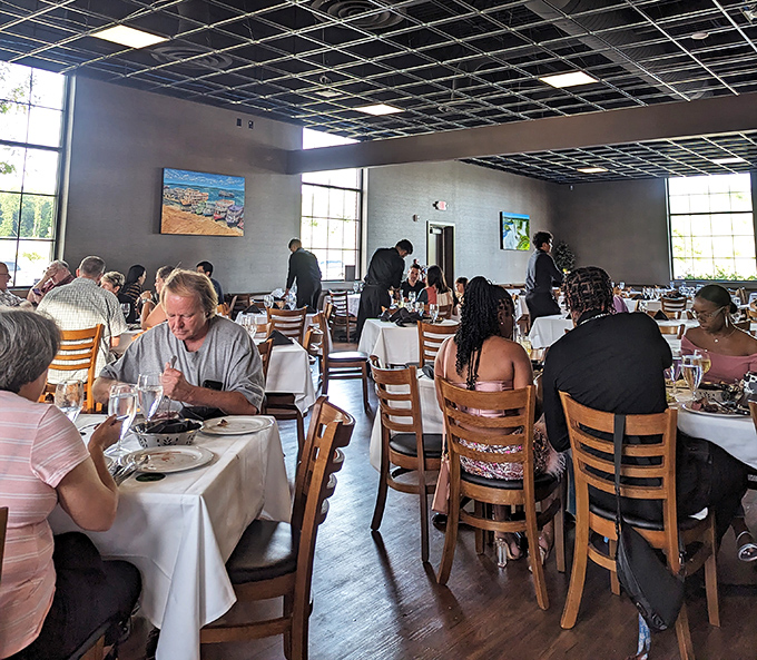 The universal language of satisfaction: diners focused intently on their plates while servers circulate with skewers of joy.