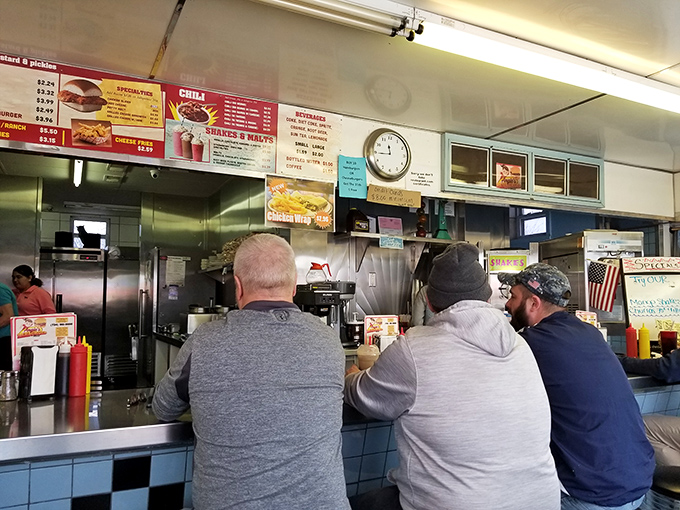 The backs of loyal customers tell a story &ndash; this is where regulars come for their burger fix, a ritual as reliable as Michigan seasons.