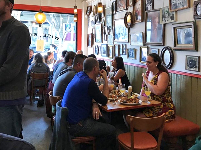 Where strangers become friends over shared pickle plates. That wall of family photos isn't decoration—it's the restaurant's ancestral LinkedIn.