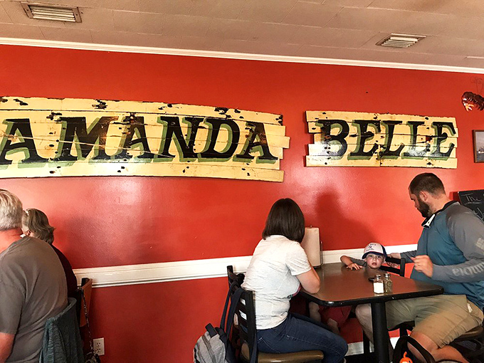 The weathered wooden sign on the wall tells stories of boats and catches that would make even the most dedicated landlubber dream of the sea.