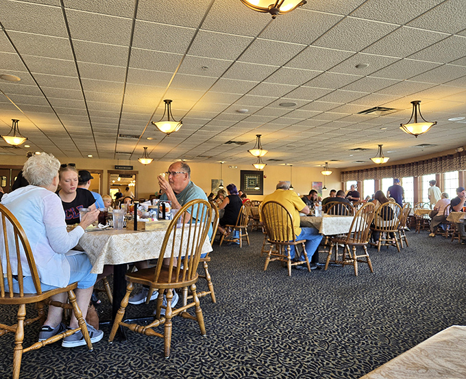 Diners enjoying the fruits of Amish cooking labor. Notice how nobody's checking their phones—the food commands complete attention.