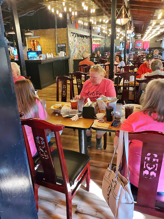 Multi-generational seafood enthusiasts gather around tables, united in the universal language of "please pass the butter for these crab legs."