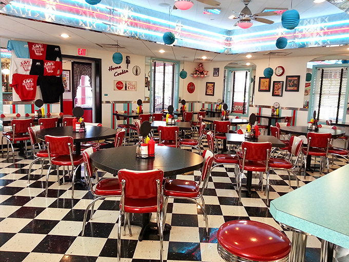 Black and white checkered floors, red chairs, and turquoise accents create the perfect backdrop for making memories over comfort food.