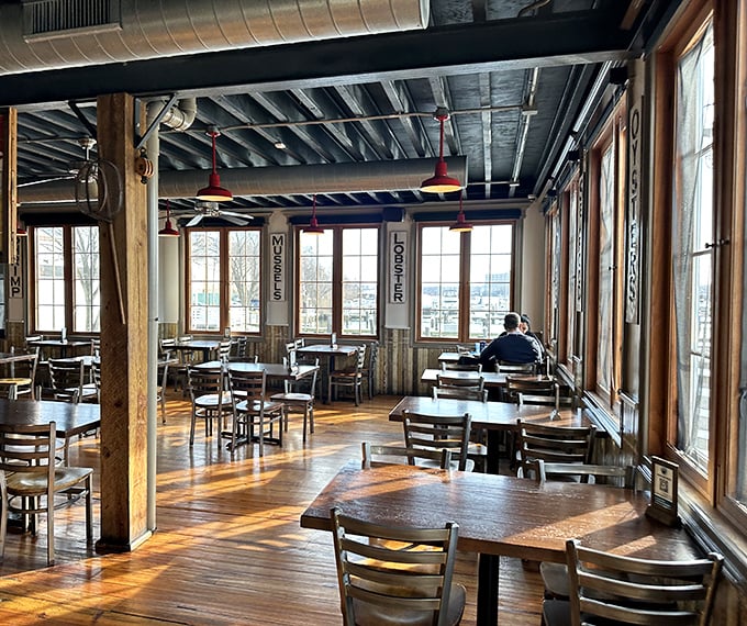 Morning light streams through windows overlooking the harbor, turning an ordinary dining room into a cathedral of seafood worship.