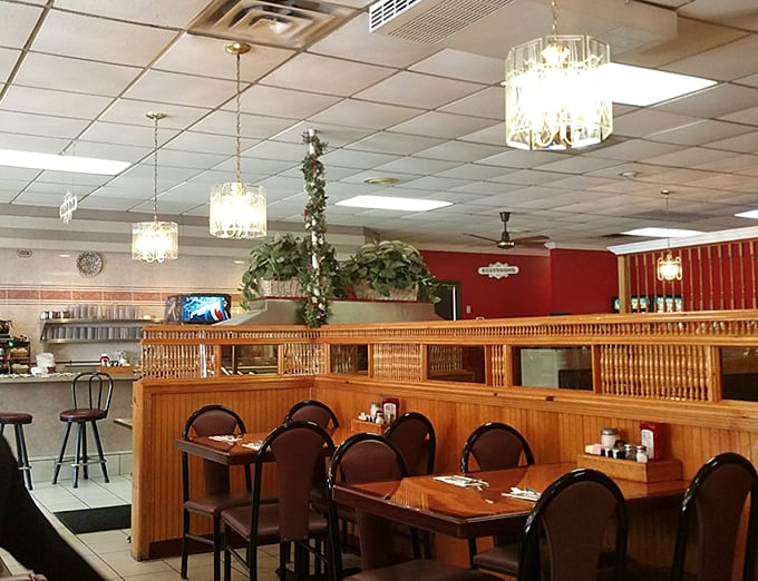 Chandeliers in a diner? That's what I call breakfast with ambition. The warm wood dividers create little kingdoms for each dining party.