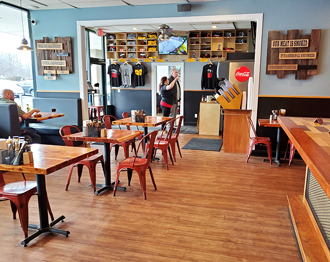 The dining area balances industrial chic with barbecue functionality. Those wooden tables have witnessed more food euphoria than a therapist's couch.