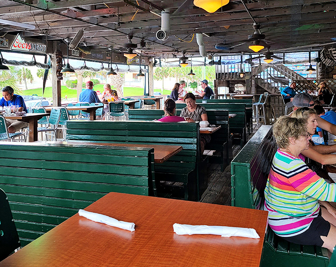 Green booth seating that's seen a thousand sunset toasts and countless "we should move here" vacation declarations.