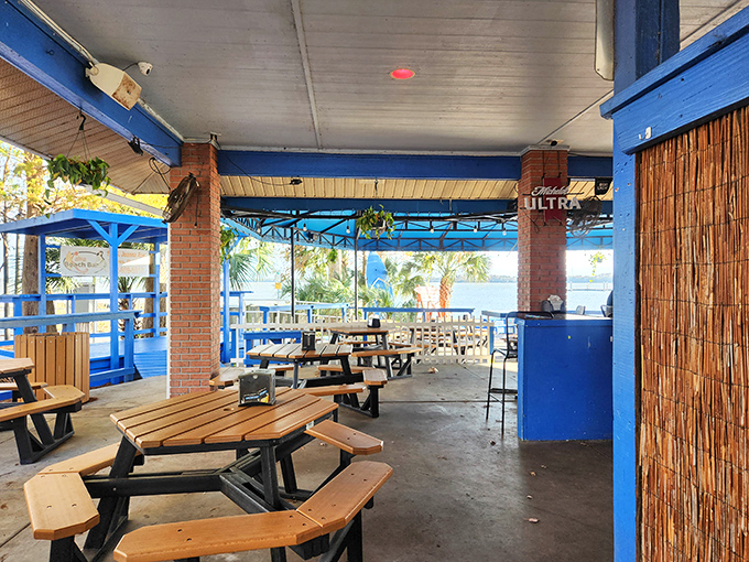 Picnic tables under shelter but open to the breeze&mdash;exactly the kind of architectural compromise that makes Florida dining magical year-round.