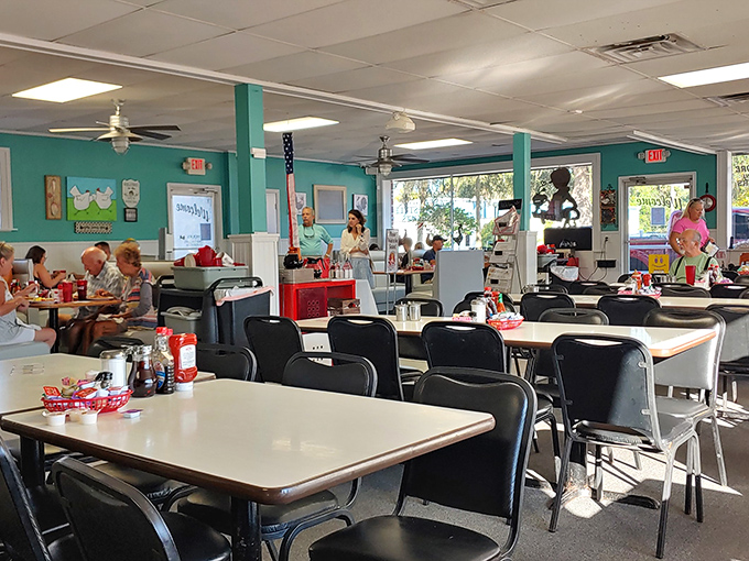 Spacious dining room with turquoise walls that feel like a warm embrace from your favorite breakfast memories.