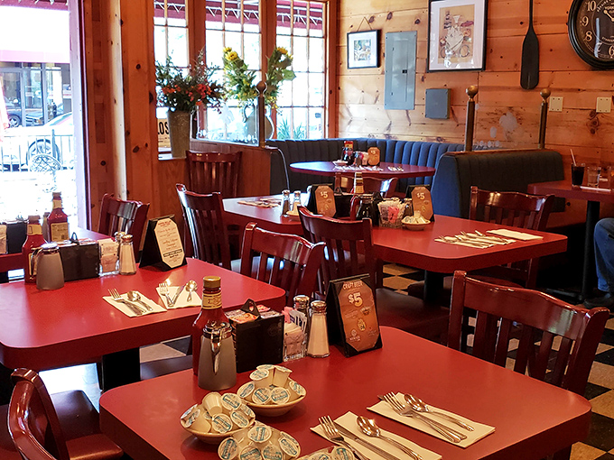 Tables set with care await the morning rush. Each red tabletop has witnessed countless first dates, family reunions, and "just because" Tuesday breakfasts.