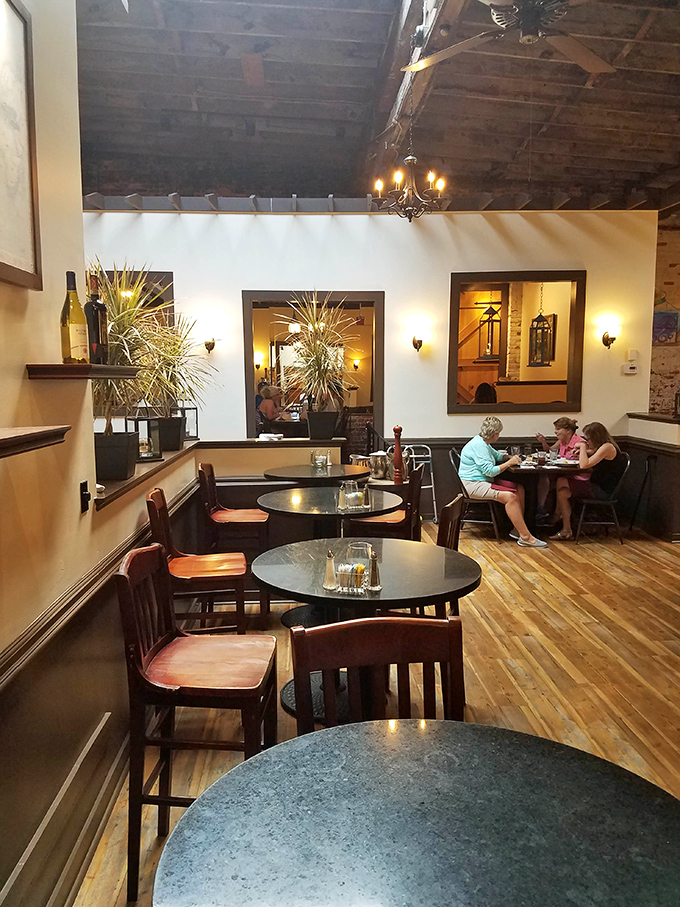 The restaurant's multi-level design creates intimate dining spaces where conversations flow as smoothly as the wine.