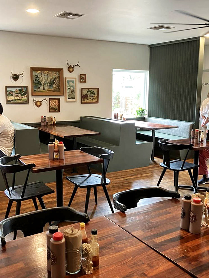 The wall art gallery of vintage paintings and antlers creates the perfect backdrop for the serious business of barbecue appreciation.