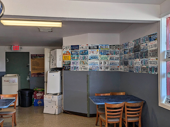 Another angle of the dining room reveals more license plates and simple furnishings &ndash; this place puts its energy into the grill, not interior design.