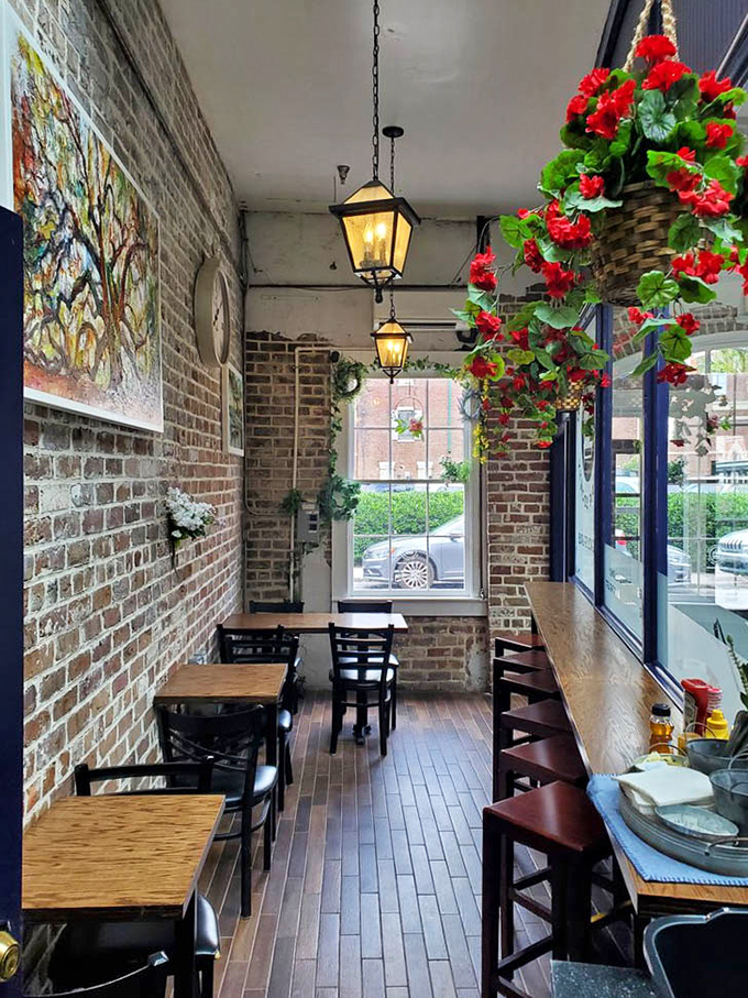 Hanging lanterns and exposed brick create a narrow dining corridor that feels like stepping into a charming English alleyway café.