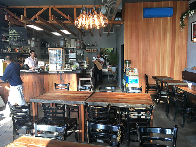 Morning light streams through windows illuminating wooden tables where breakfast magic happens daily &ndash; no wizards required, just talented cooks.