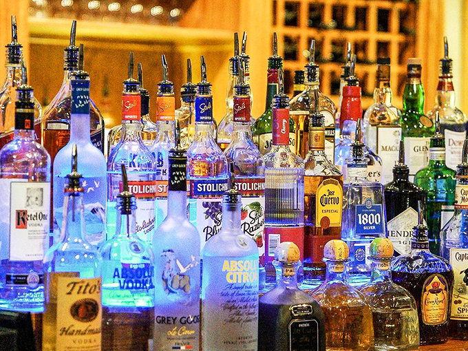 The bar's illuminated bottles create a liquid light show that promises good times and possibly tomorrow's headache.