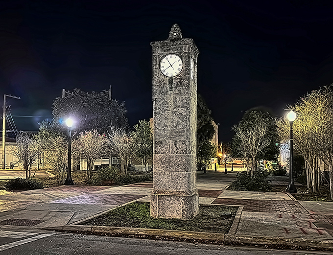 The town clock stands sentinel over Lake Wales after dark, illuminated like a limestone lighthouse guiding locals home after an evening of small-town revelry.
