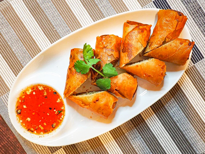 These golden-fried spring rolls, crispy on the outside and steaming within, are the perfect ambassadors to Thai cuisine's complex flavors.