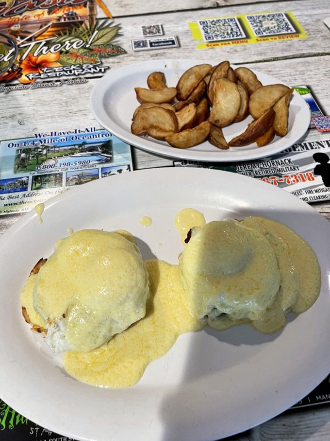 Eggs Benedict with home fries&mdash;proof that hollandaise sauce is less a condiment and more a life philosophy worth embracing.
