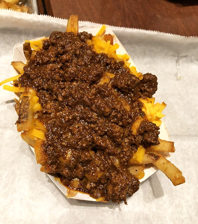 Elvis would approve of these loaded fries—a glorious mess of savory toppings that transforms the humble potato into a headline act.