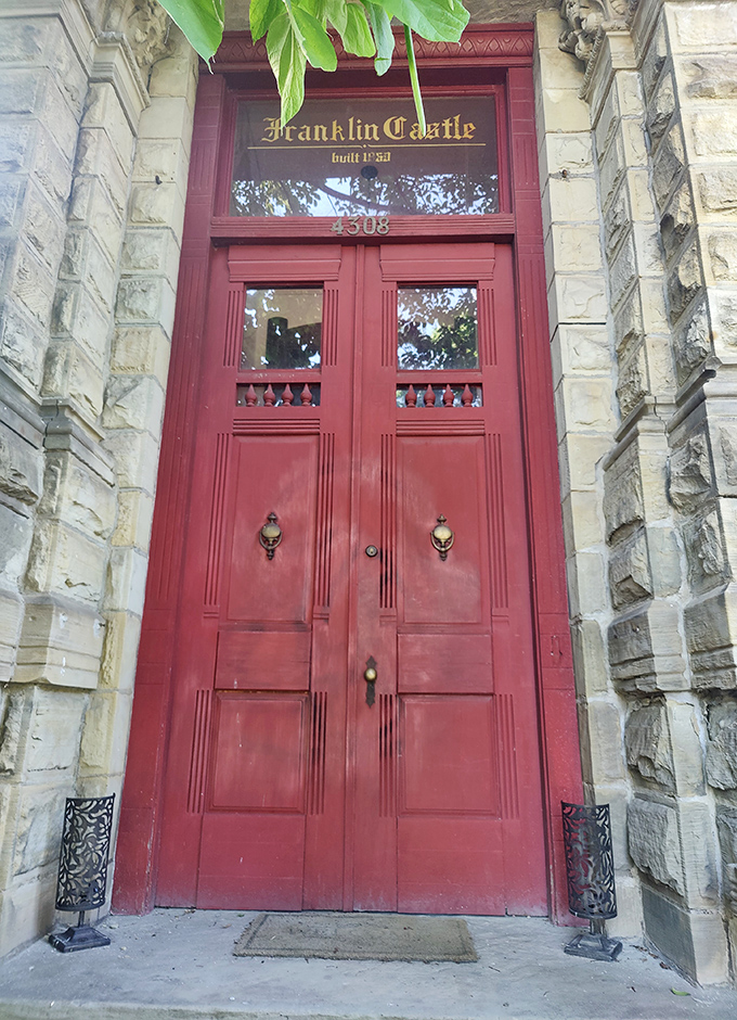 The castle's crimson doors welcome visitors with ornate detailing and just a hint of "enter if you dare" energy.
