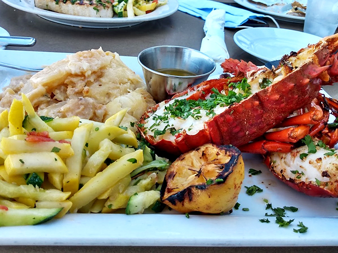 The fisherman's platter that makes you grateful for whoever first thought to put seafood on a plate. That grilled lemon isn't just garnish&mdash;it's a game-changer.