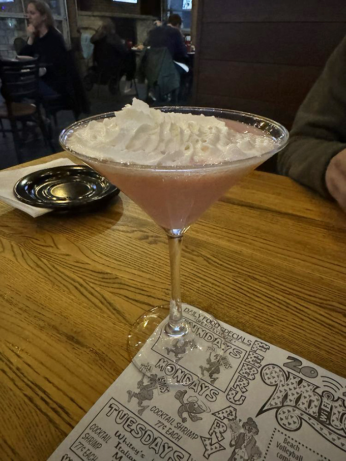 A martini that doesn't just arrive&mdash;it makes an entrance. Pink, proud, and topped with enough whipped cream to make a barista jealous.