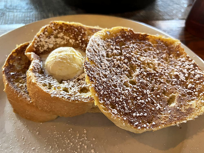 French toast that's dressed for success with a dusting of powdered sugar and a crown of butter melting into every pore.