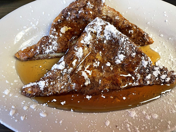 French toast that would make actual French people reconsider their citizenship. Dusted with powdered sugar and swimming in syrup&mdash;breakfast as dessert is always the right choice.