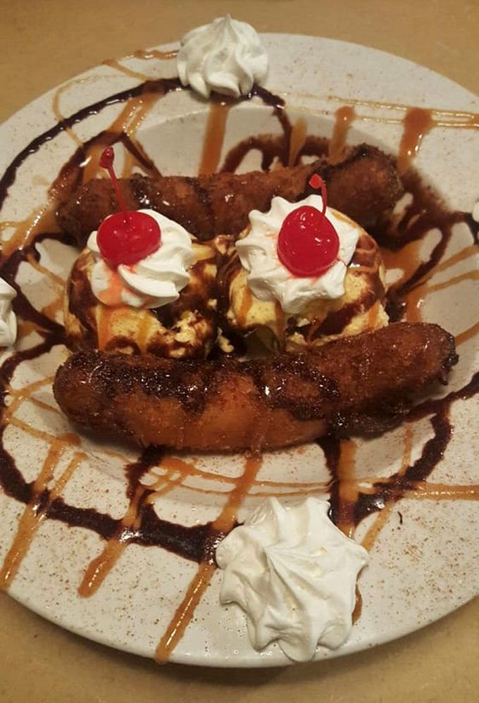 Dessert that laughs at restraint. Fried bananas with ice cream, whipped cream, and cherries&mdash;because after smoked meat, why start being sensible now?