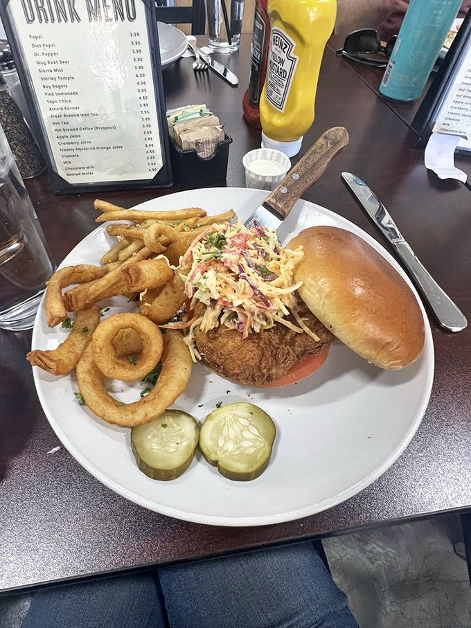 Crispy meets juicy in this fried chicken sandwich. The slaw adds crunch, the pickles add tang, and the fries add pure happiness.
