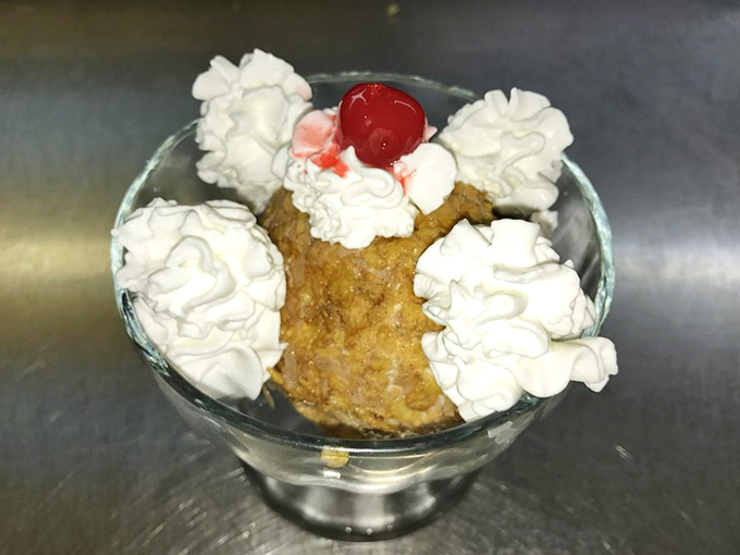 Fried ice cream: the dessert that defies physics—hot, crispy exterior giving way to cool, creamy ice cream, topped with clouds of whipped cream.