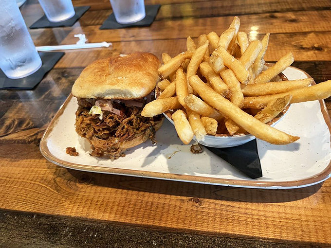 Golden fries alongside a sandwich that's practically collapsing under the weight of its own deliciousness &ndash; a perfect partnership.