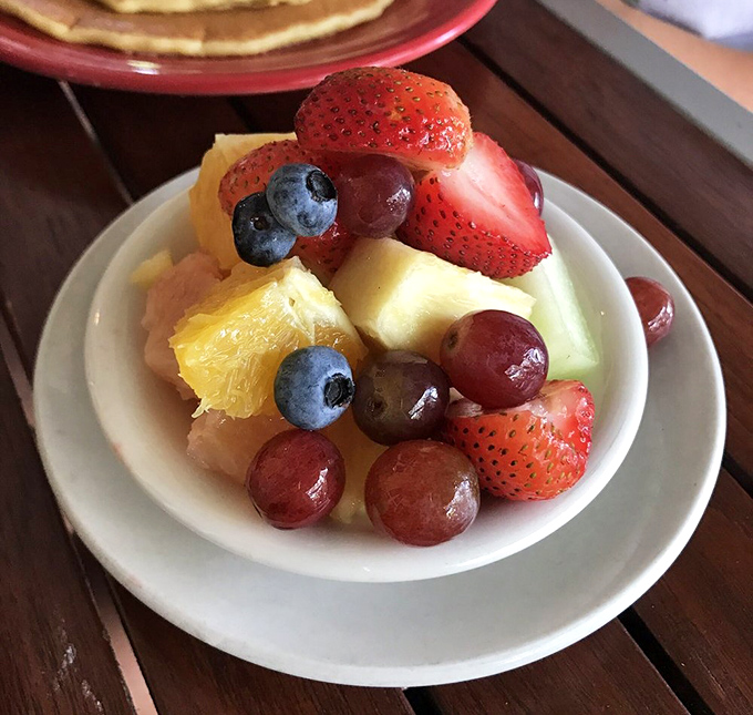 A fruit salad that actually looks like someone cared – vibrant, fresh, and arranged with the respect berries and melons deserve.