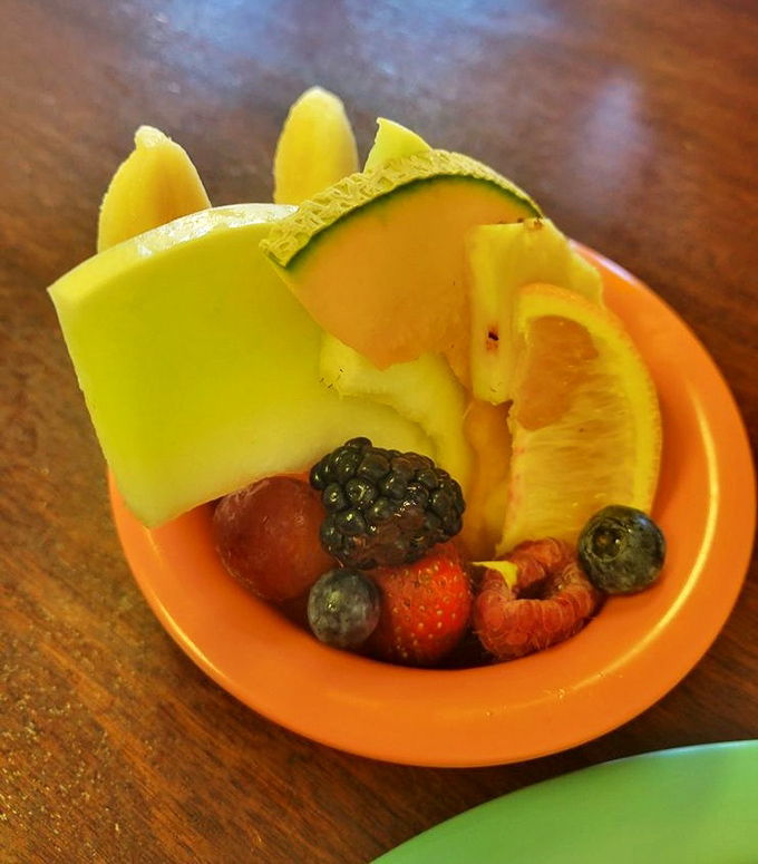 Nature's candy arranged in a cheerful orange bowl&mdash;a fresh fruit medley that somehow tastes better here than from your own refrigerator.