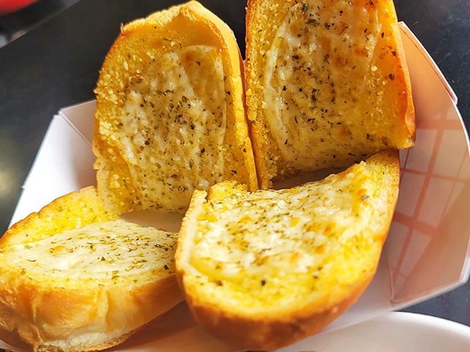 Garlic bread transforms into edible gold when kissed with oregano, Romano, and melted provolone cheese.