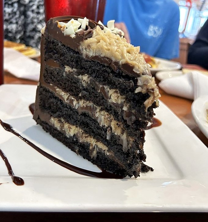 A slice of German chocolate cake so decadent it should require a permission slip. Those layers aren't playing around.