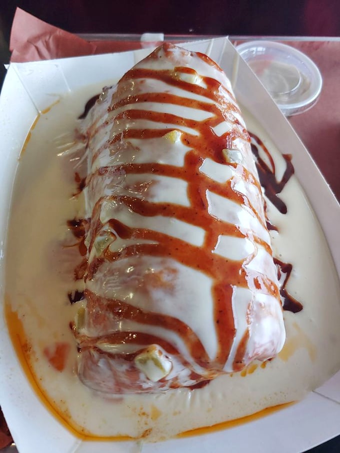 This burrito-sized creation drizzled with sauce is what happens when barbecue decides to dress up fancy, but can't quite hide its deliciously messy soul.
