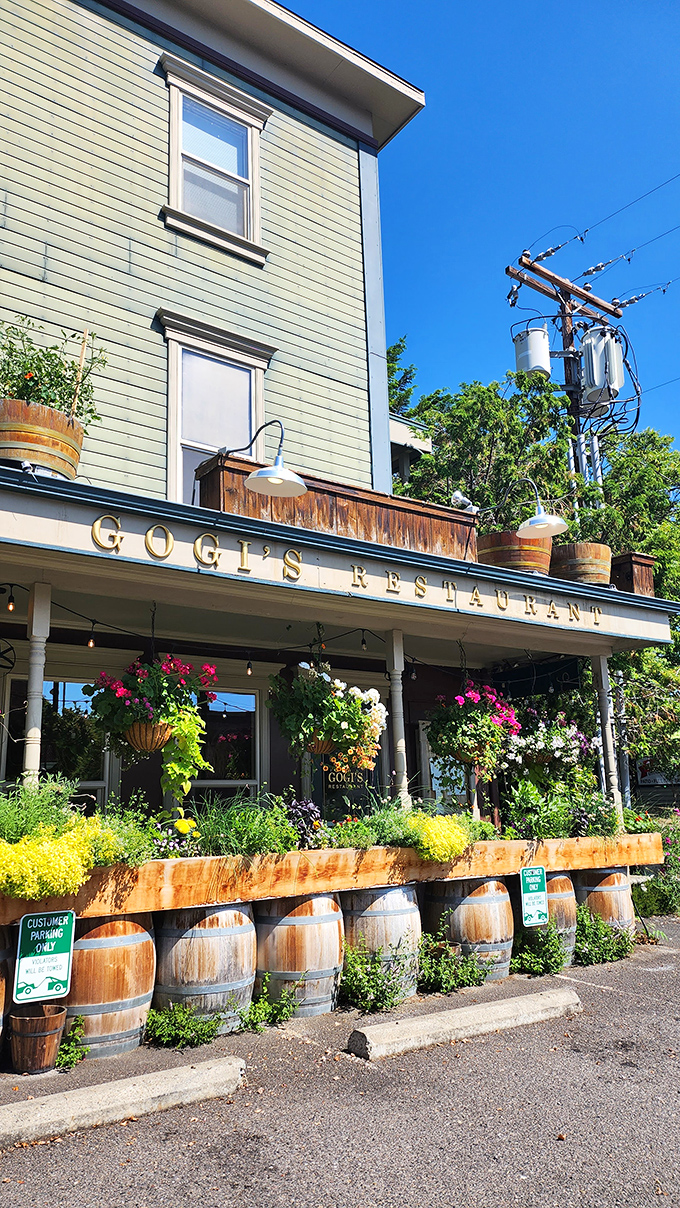 Gogi's Restaurant wraps sophisticated dining in a historic building, where wine barrels and hanging flowers create the perfect backdrop for culinary magic.