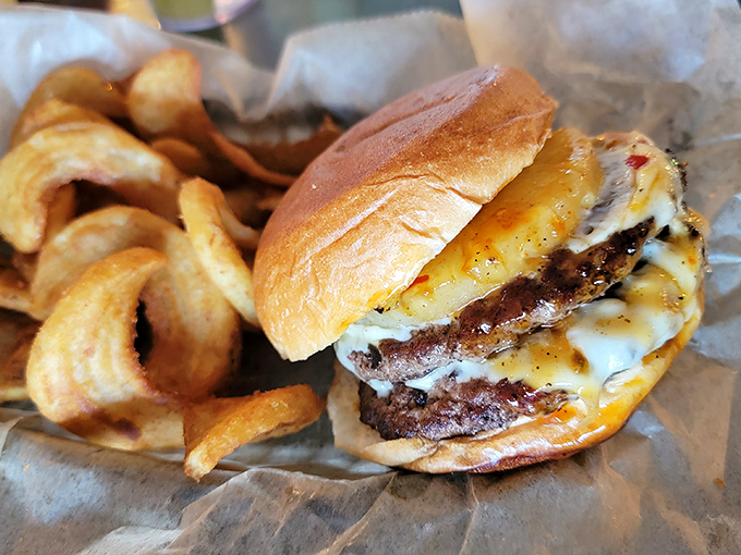 The Harbor House burger arrives stacked higher than your expectations, delivering satisfaction in every messy, wonderful bite.
